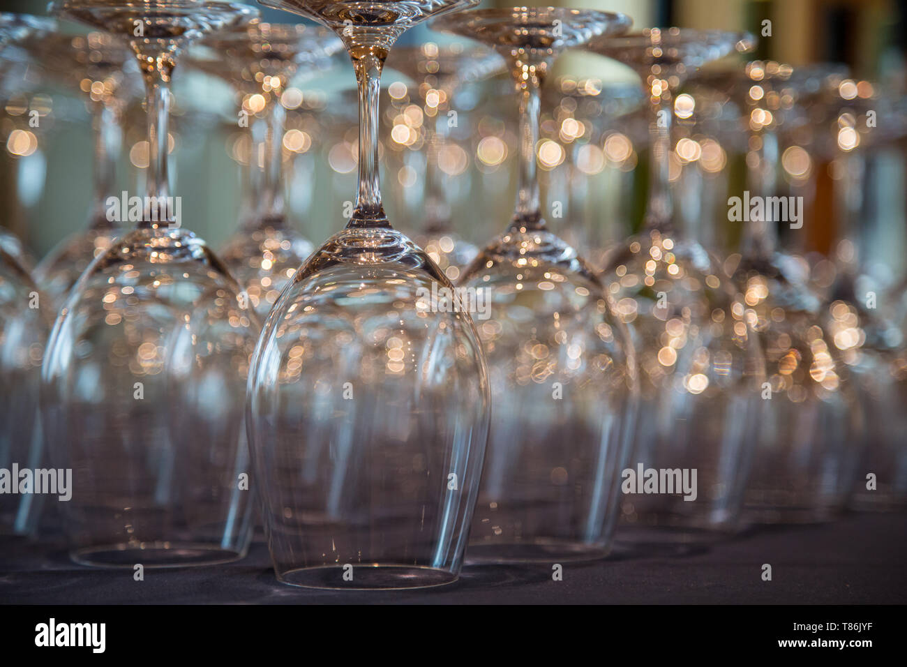Bar row empty vine glasses hanging upside down background Stock Photo ...