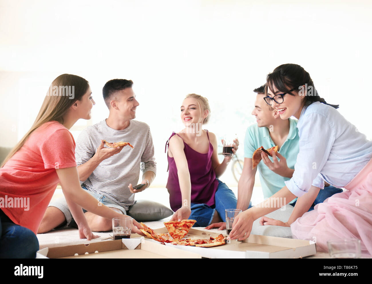 Young people having fun at party with delicious pizza indoors Stock ...