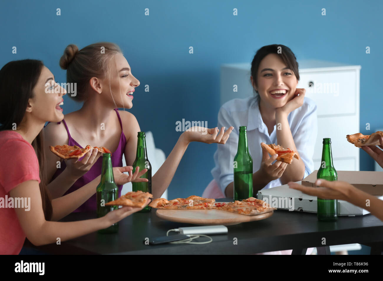 Young people having fun at party with delicious pizza indoors Stock ...