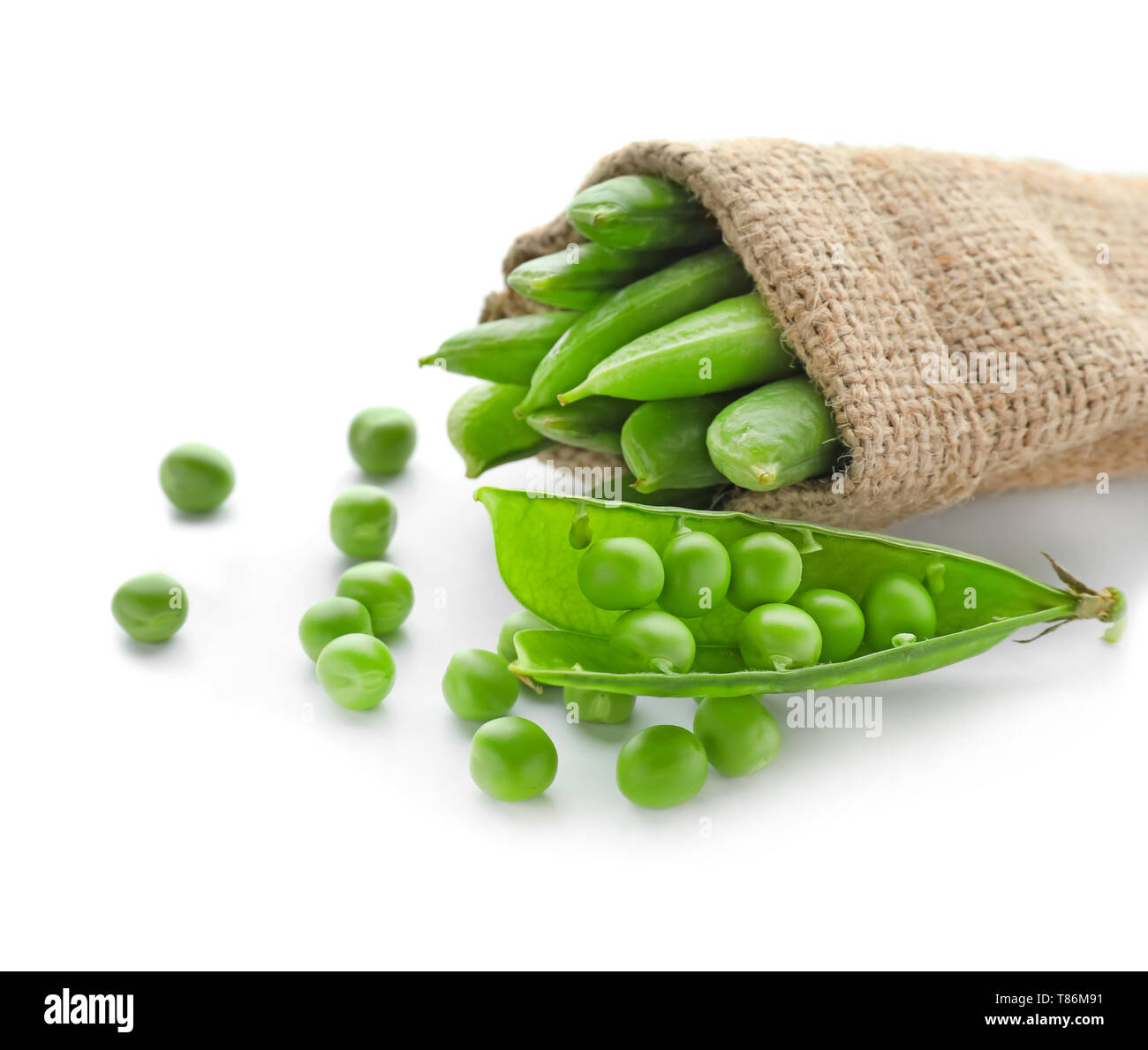 Bag with fresh green peas on white background Stock Photo - Alamy