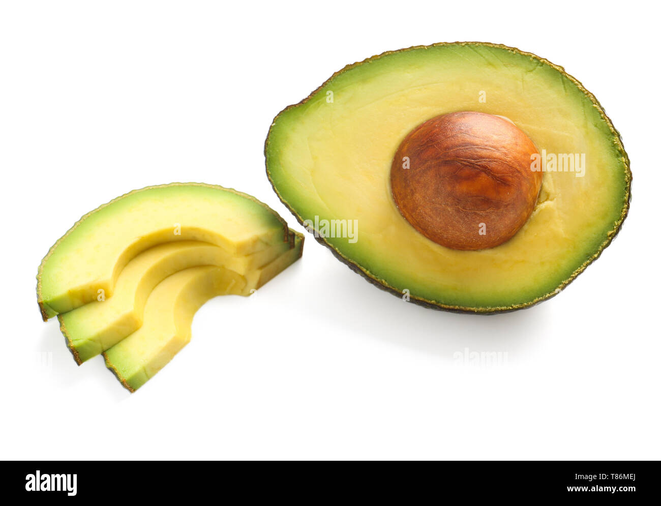 Half of fresh avocado with slices on white background Stock Photo - Alamy