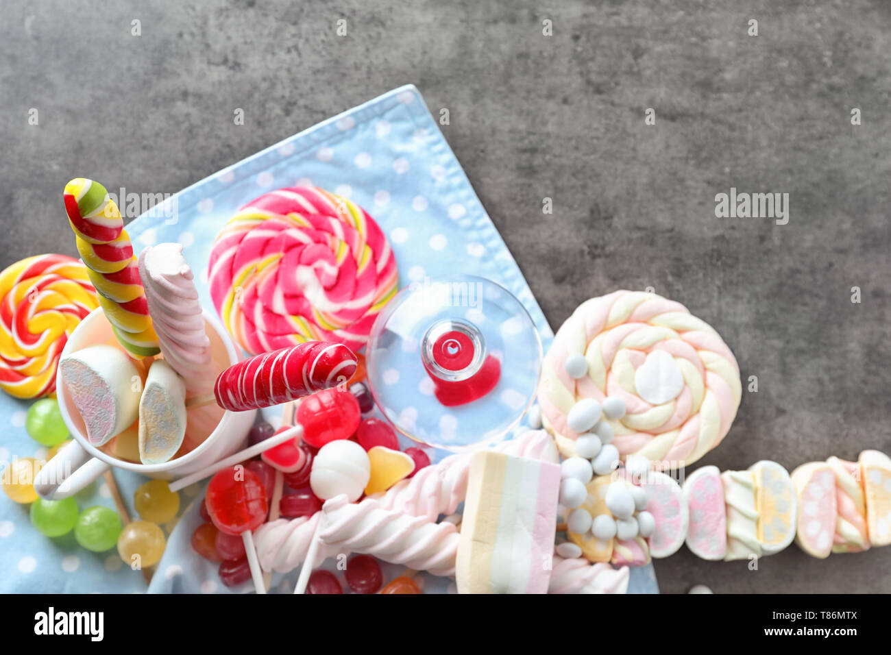 Colorful candies with marshmallows on grey background Stock Photo - Alamy