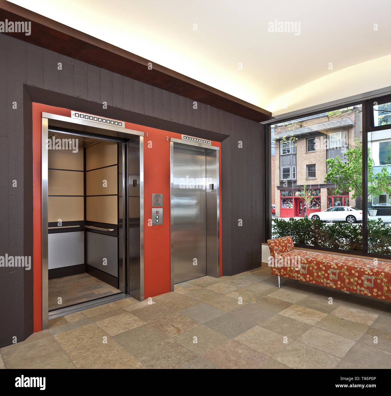 Stainless Steel Elevator Doors And A Bench Seat Stock Photo - Alamy