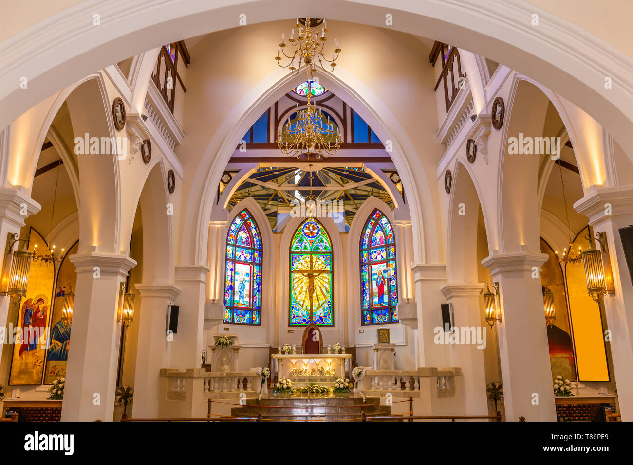 Interior view of beautiful colorful church with empty pews and warm ...