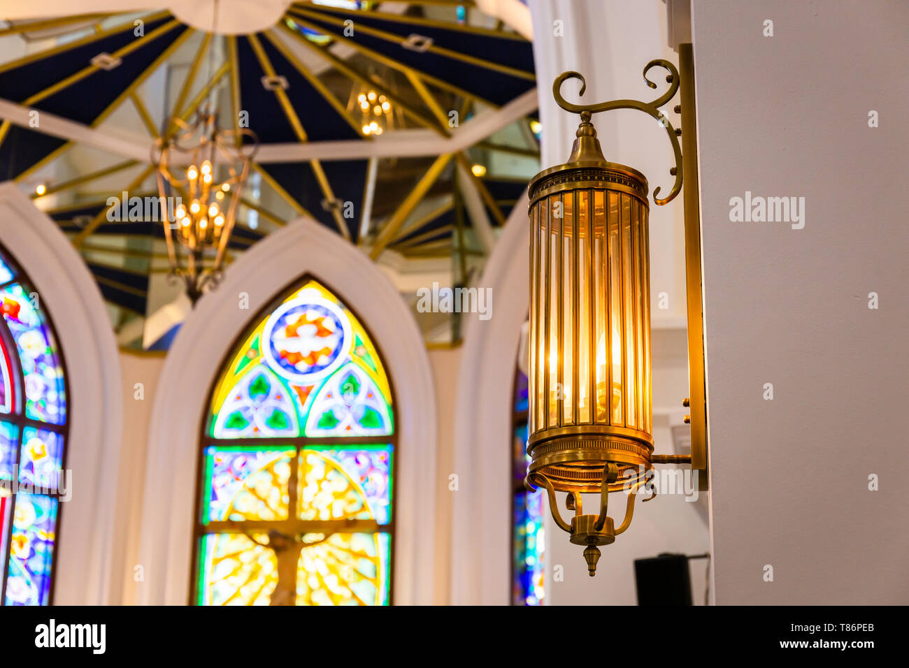 Interior view of beautiful colorful church with empty pews and warm ...