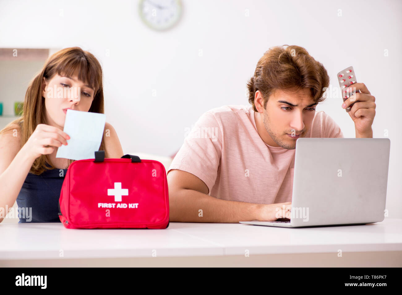 Young family getting treatment with first aid kit Stock Photo - Alamy