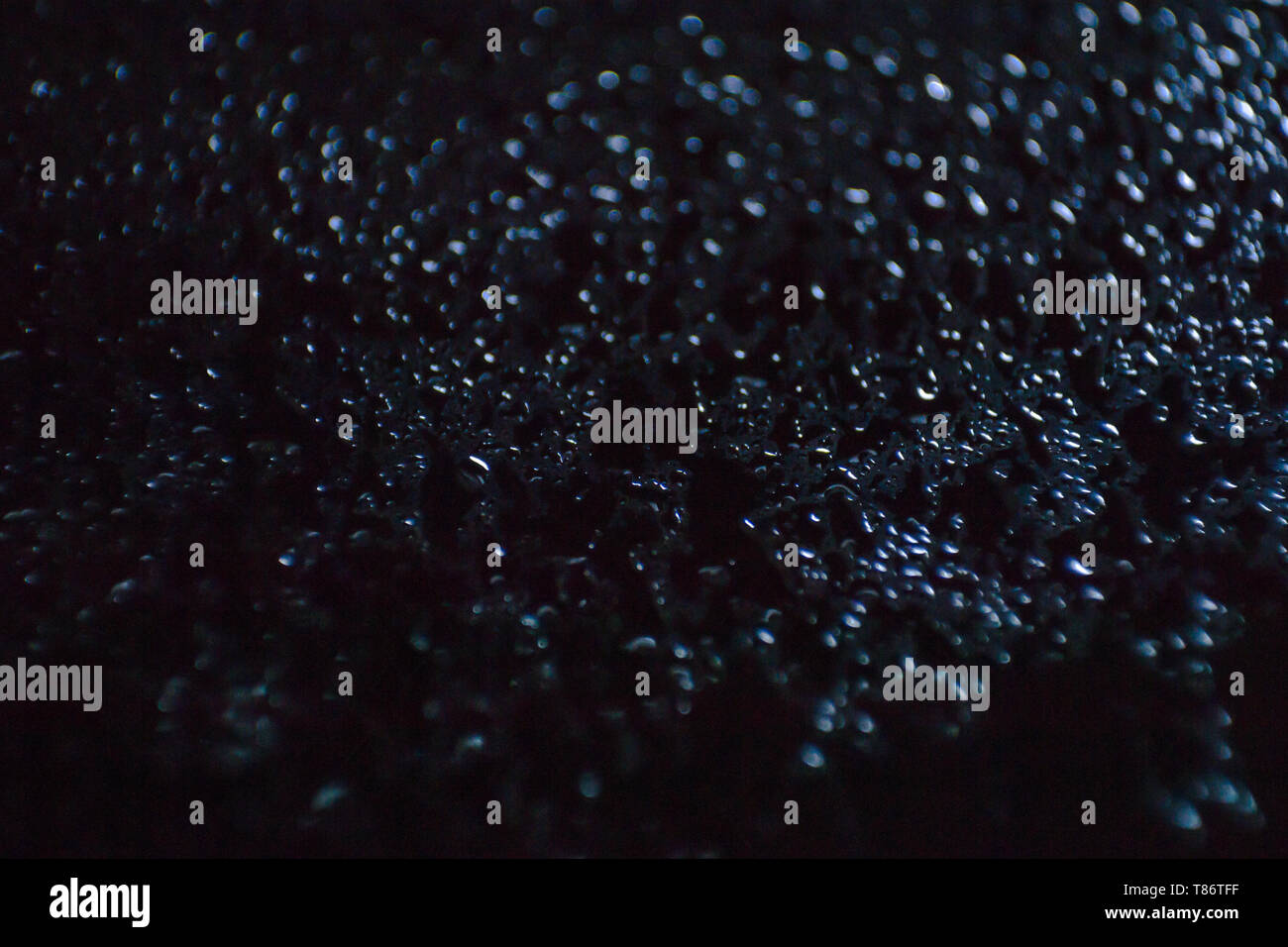 oil and water drops on black glass surface abstract background Stock ...