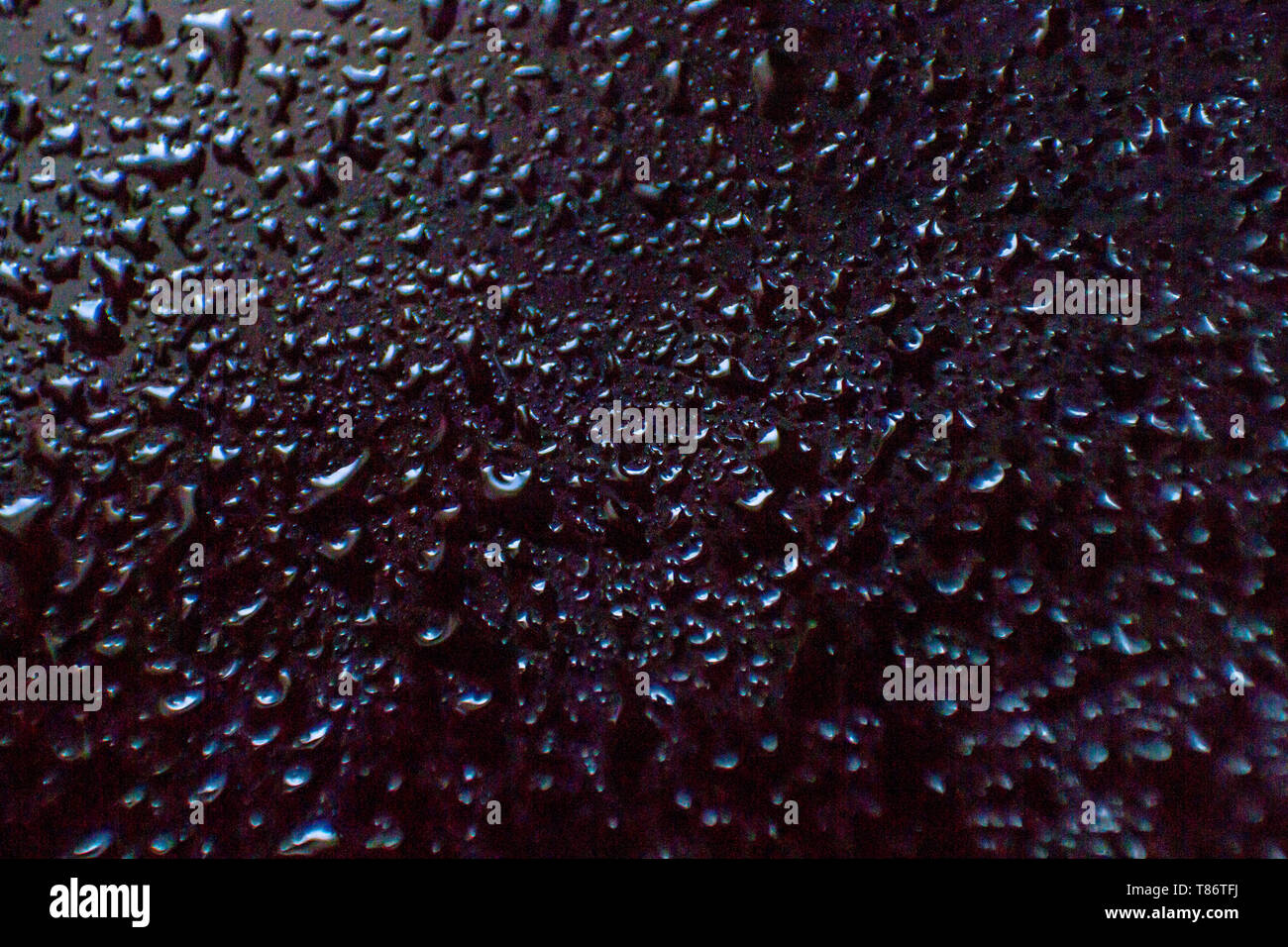 oil and water drops on black glass surface abstract background Stock ...