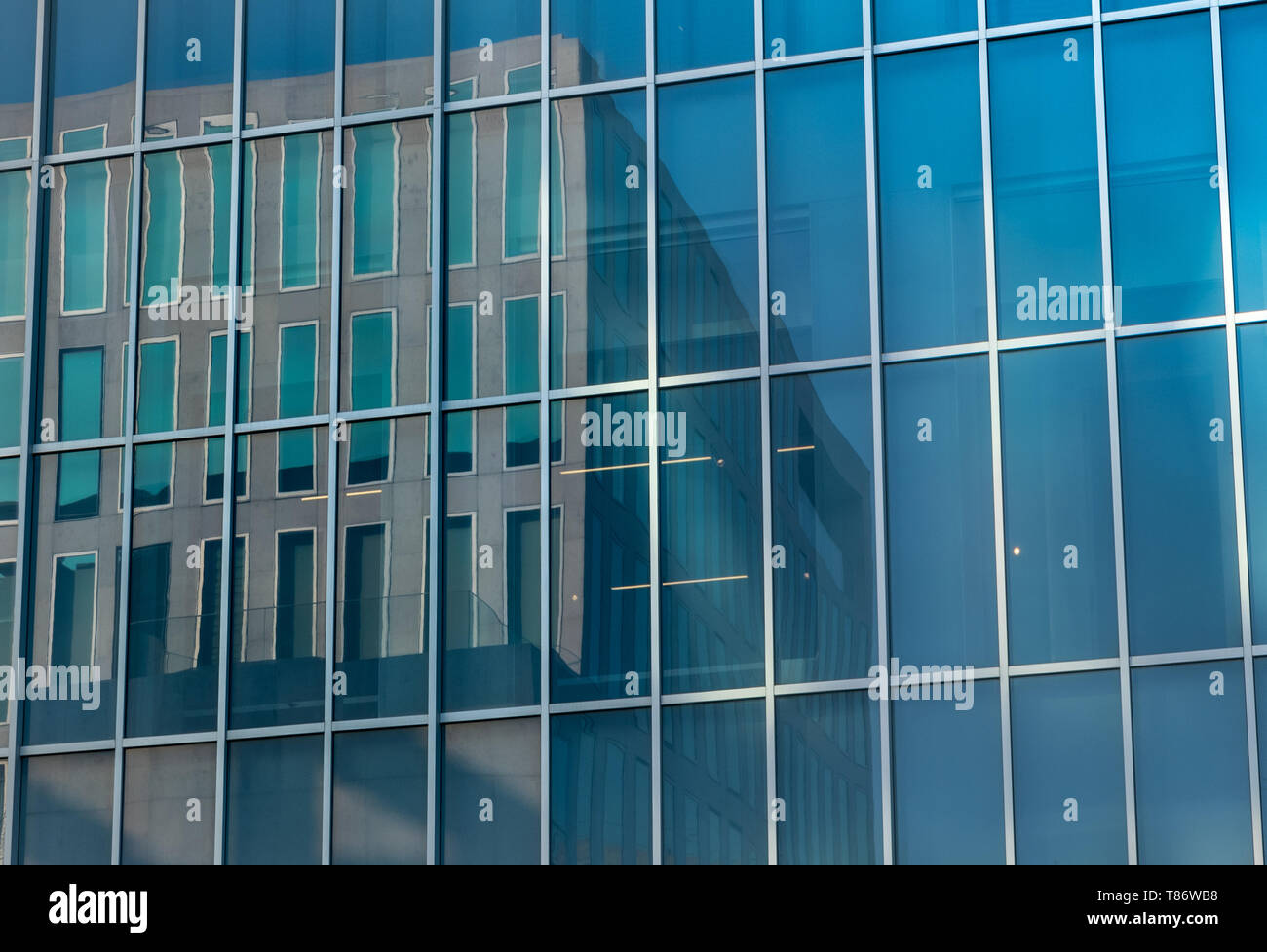 building reflected on glass facade wall of building, Architecture ...