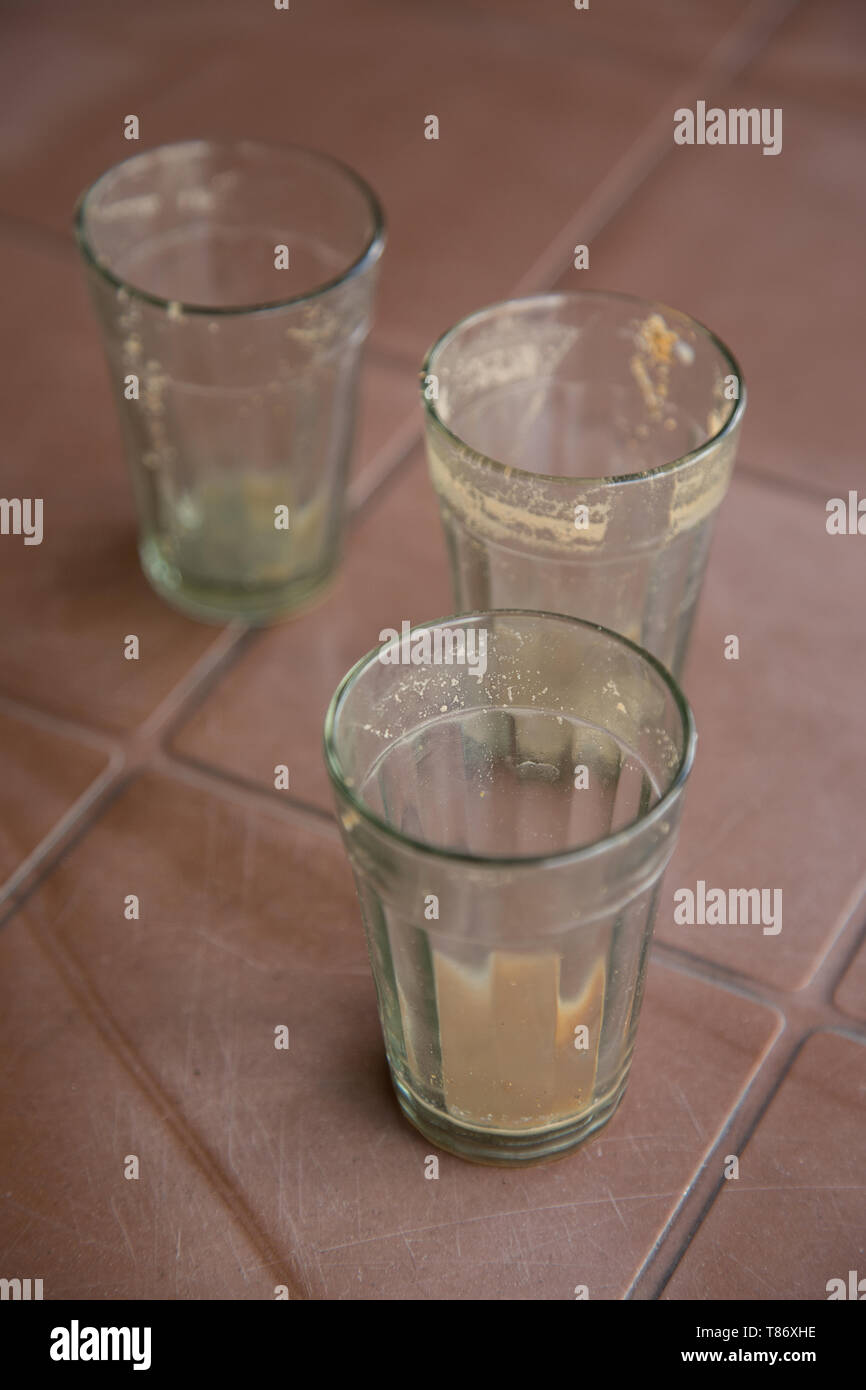 Three empty tea glasses on plastic table Stock Photo - Alamy