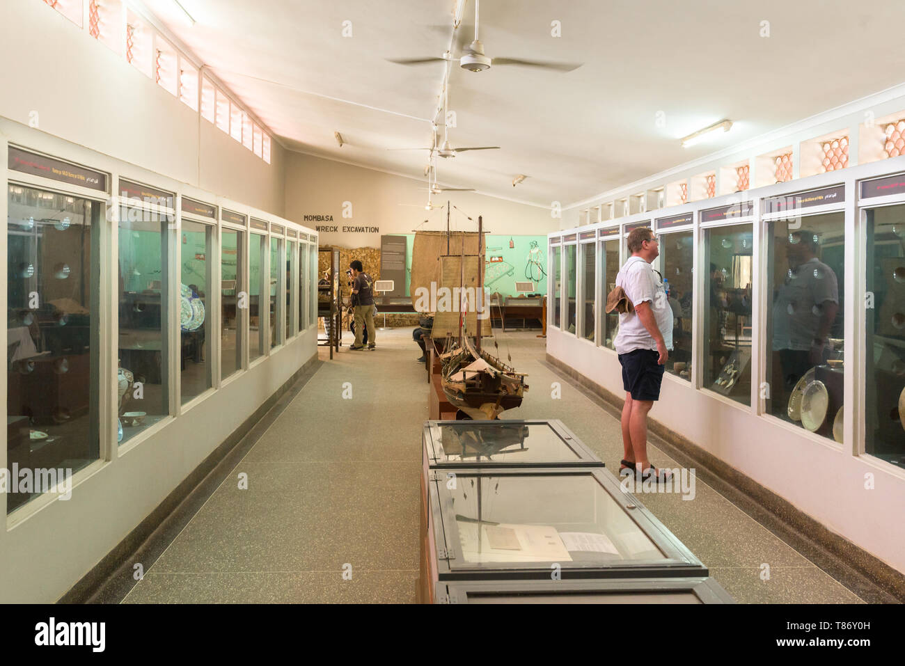 Interior of the Fort Jesus museum gallery with tourists viewing the ...