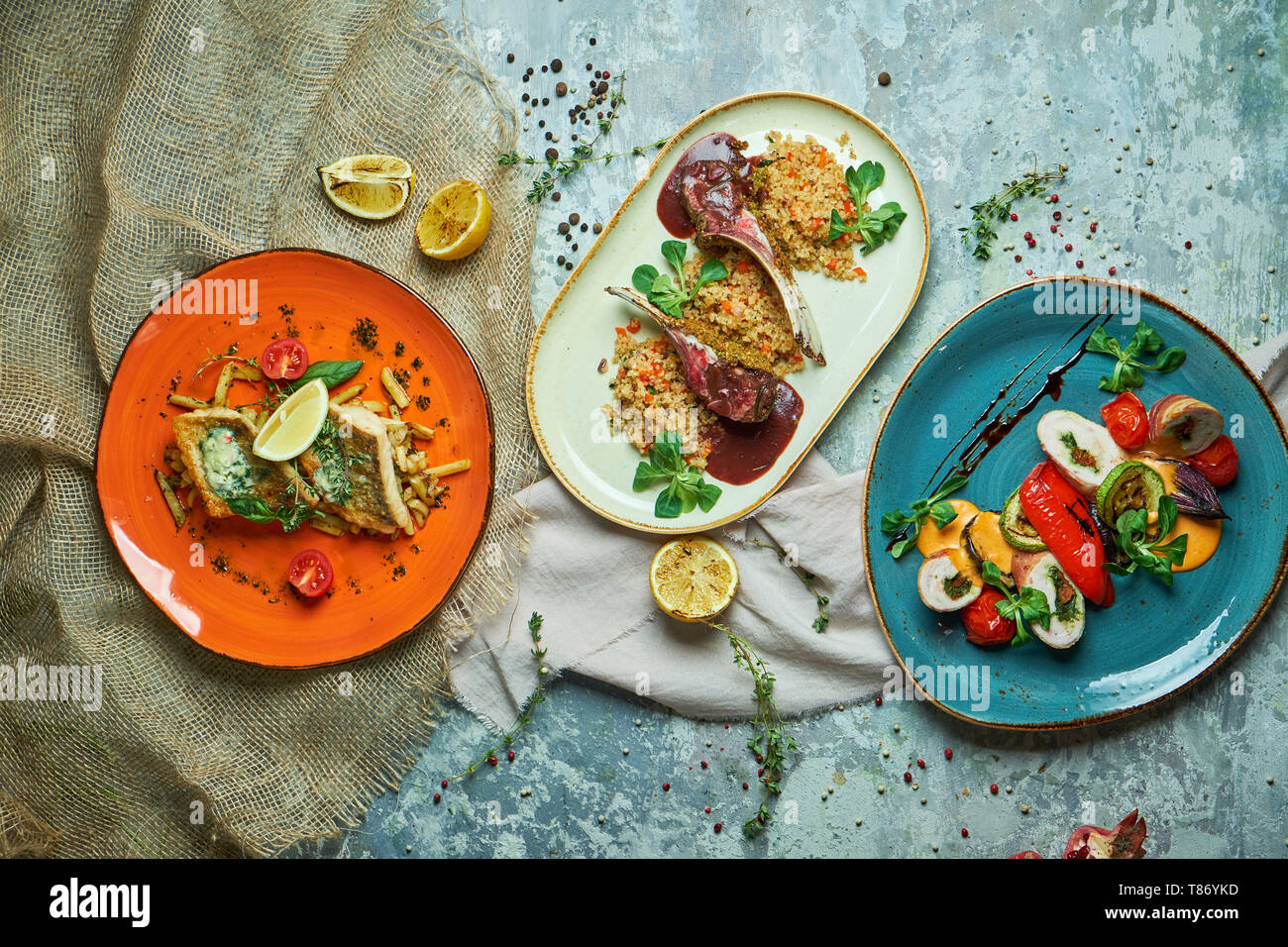 Three dishes with lamb ribs grilled fish with grilled vegetables svrhu ...