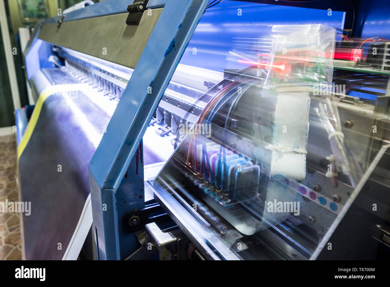 Inkjet print head motion working on blue vinyl banner Stock Photo - Alamy