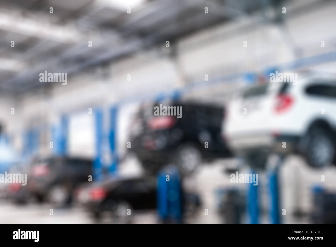 Blurred scene cars lifting repair check and fix a problem in garage ...