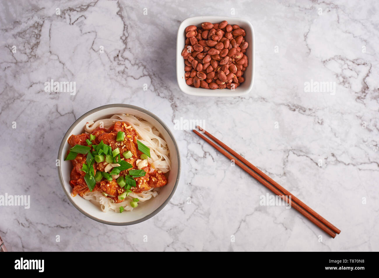 shan noodles with peanuts and chopsticks at white marble tabletop ...