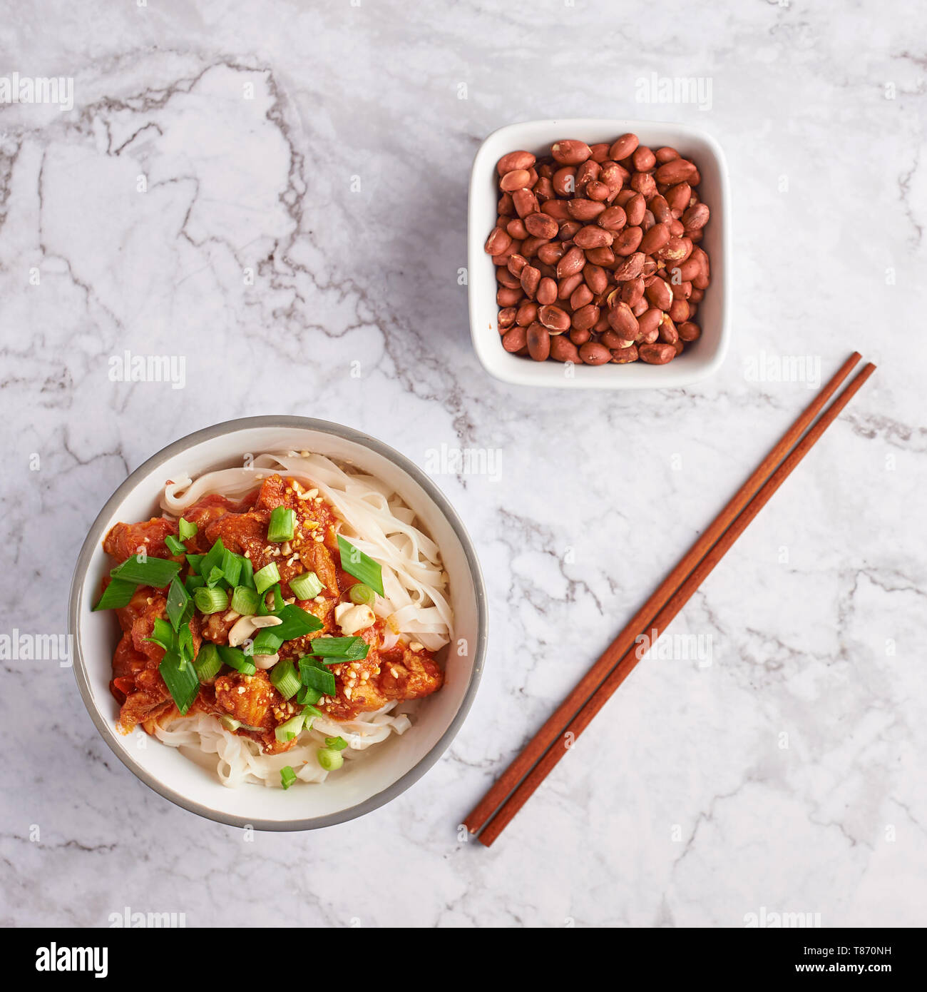 shan noodles with peanuts and chopsticks at white marble tabletop ...