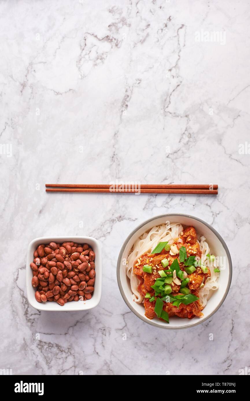 shan noodles with peanuts and chopsticks at white marble tabletop ...