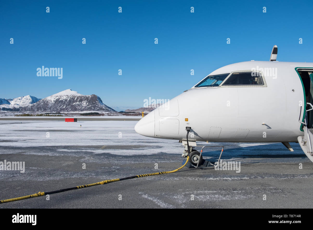 Domestic airplane refueling oil with a fuel line in airport Stock Photo ...
