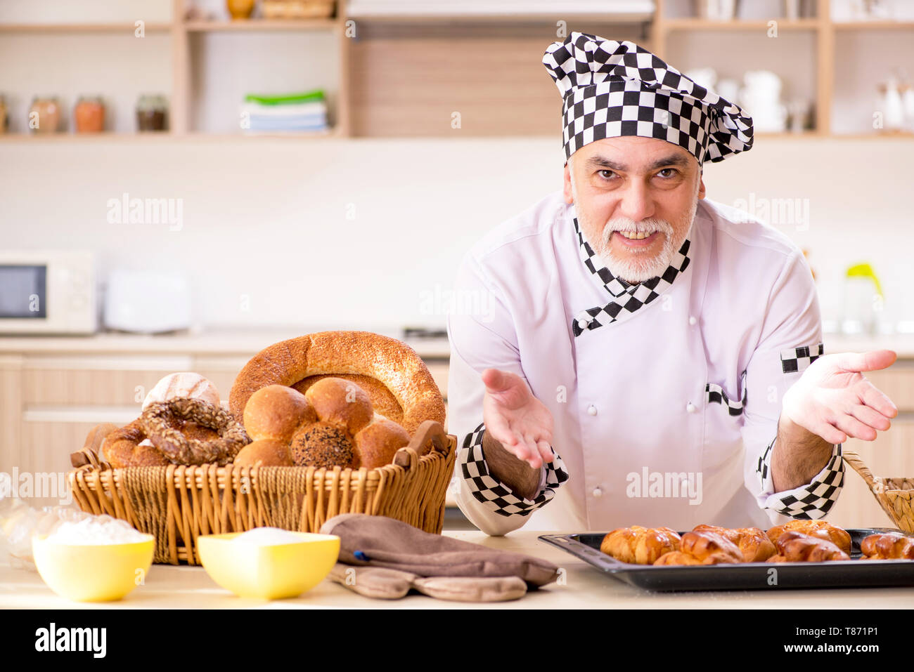 Happy baker presenting loaf bread hi-res stock photography and images ...
