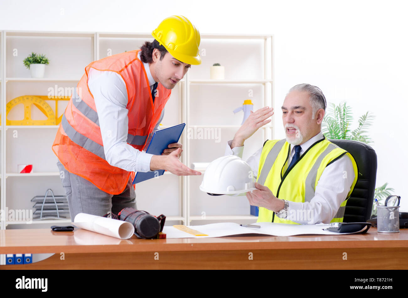 Two engineers colleagues working under project Stock Photo - Alamy
