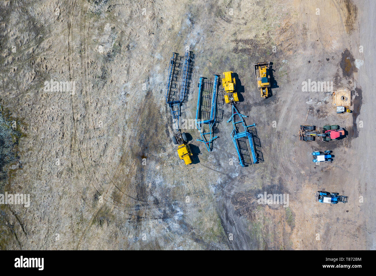 Top view on agricultural machinery near the hangar in the village for ...