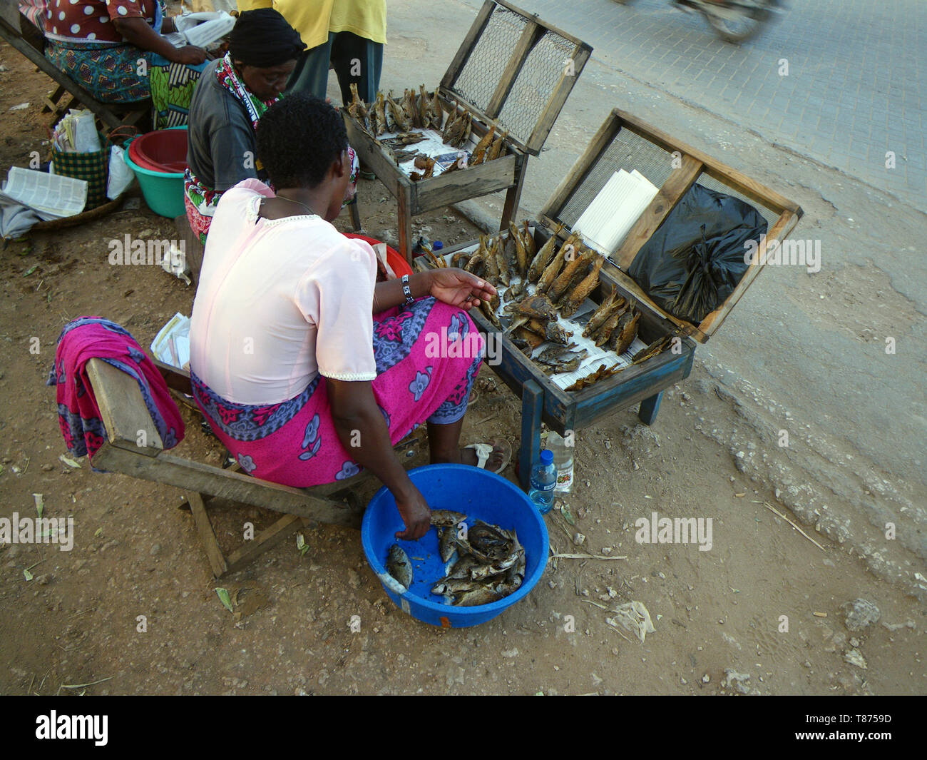 Malindi, Kenya - October 2011: an African fish vendor is waiting for ...