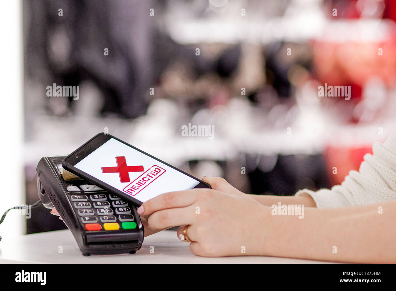 POS terminal, Payment Machine with mobile phone on store background ...
