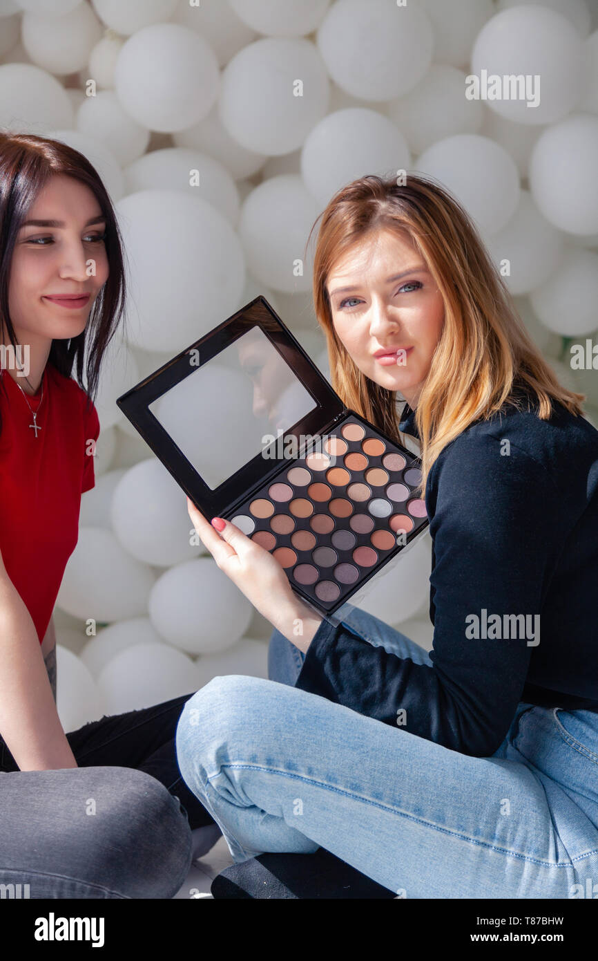 Makeup artist doing professional make up, applies eye shadows to ...