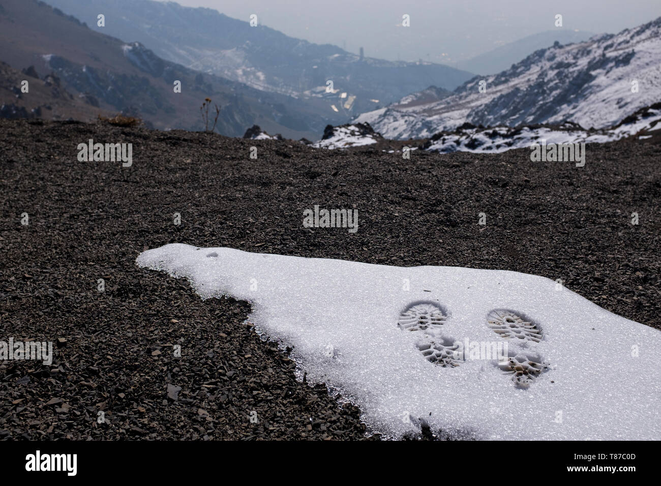 Boots foot steps on snow ground Stock Photo - Alamy