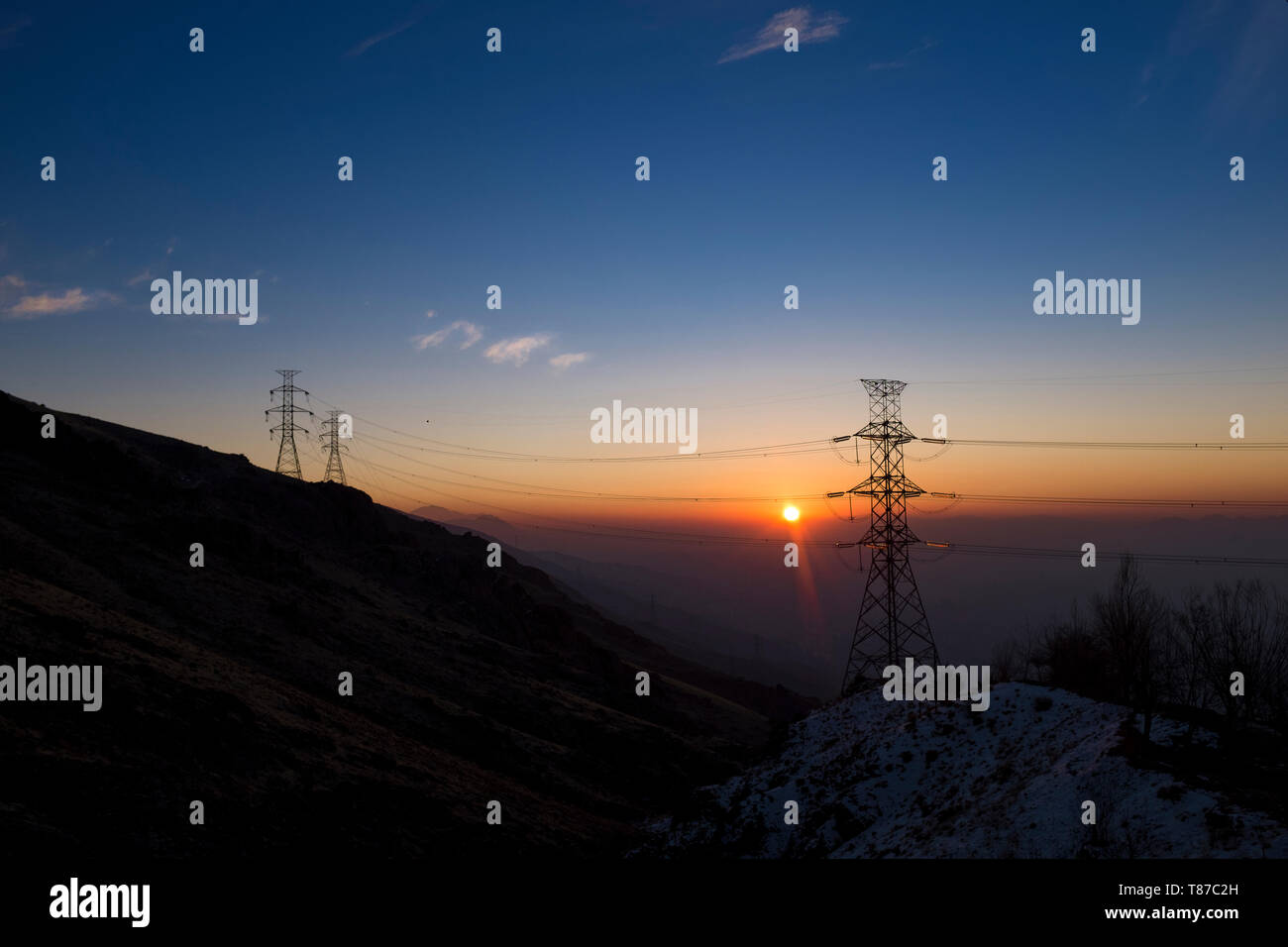 Electricity Pylon overhead power line transmission tower at sunset ...