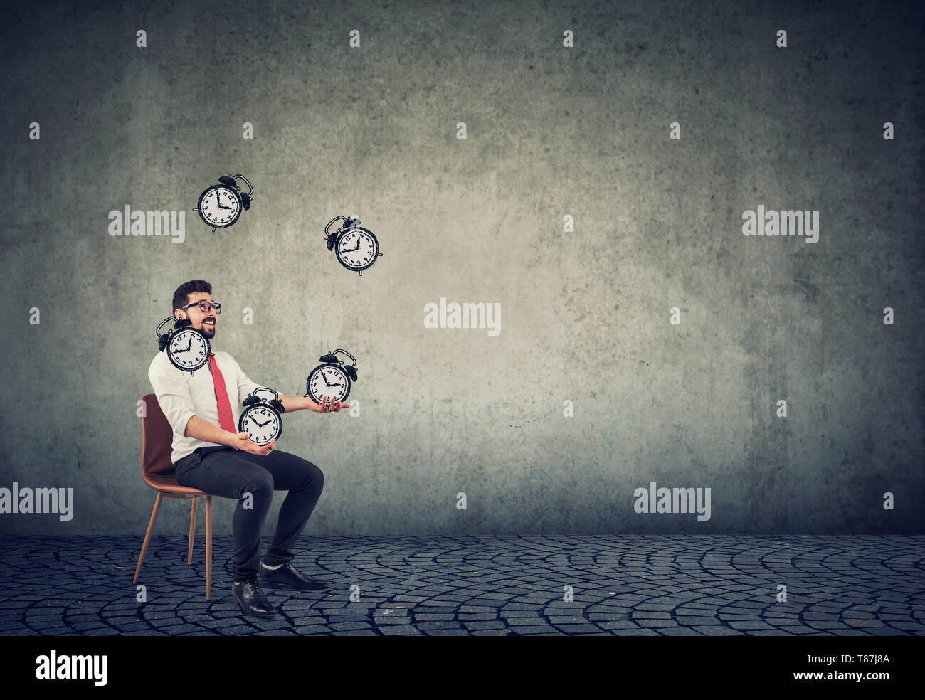 Businessman juggling alarm clocks hi-res stock photography and images ...