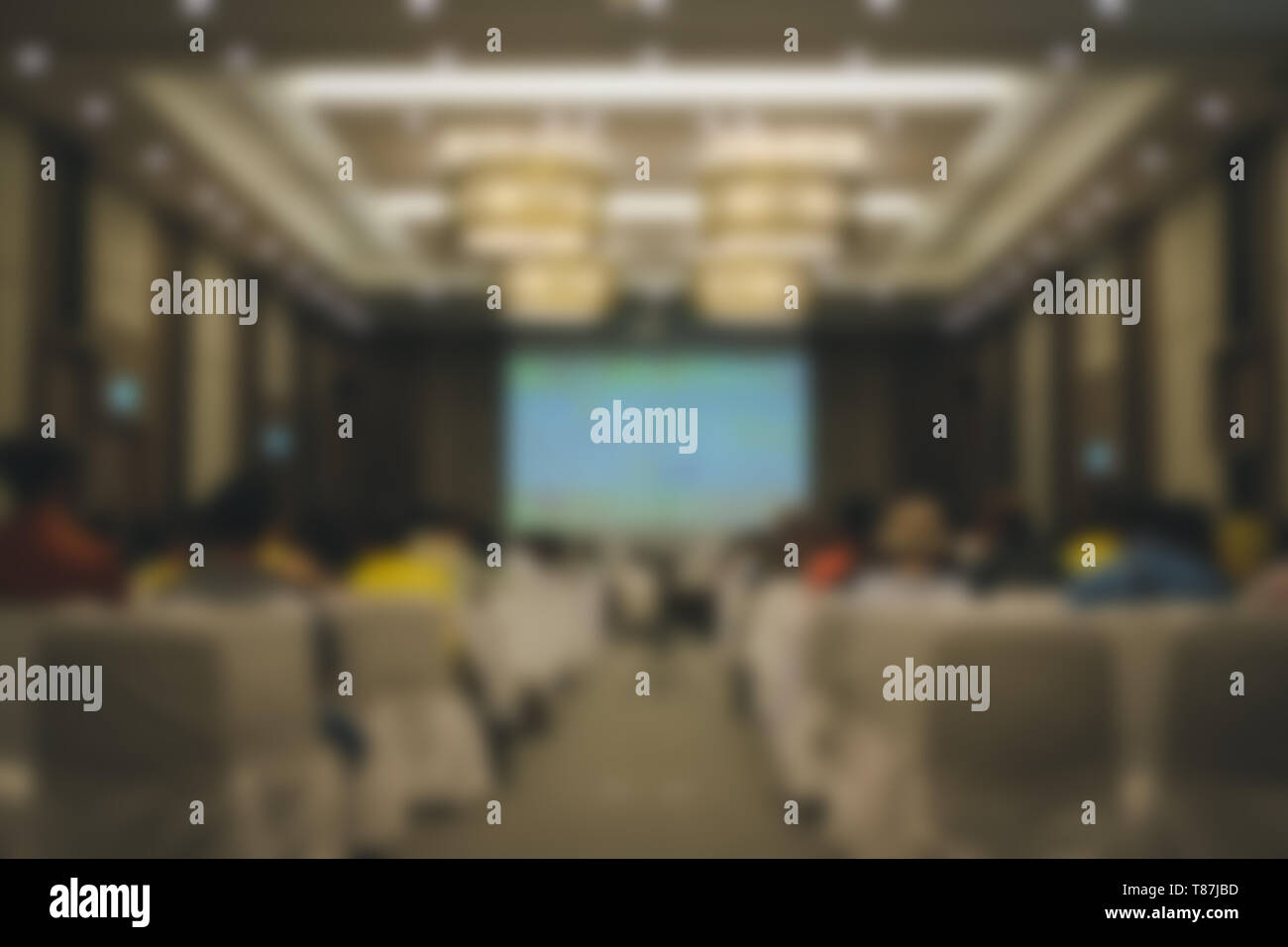 audience & stage in seminar conference room. blur defocused background ...