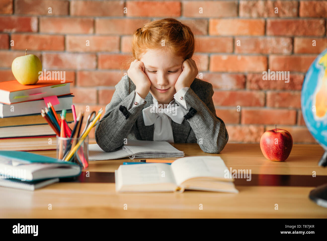Schoolgirl tired doing homework hi-res stock photography and images - Alamy