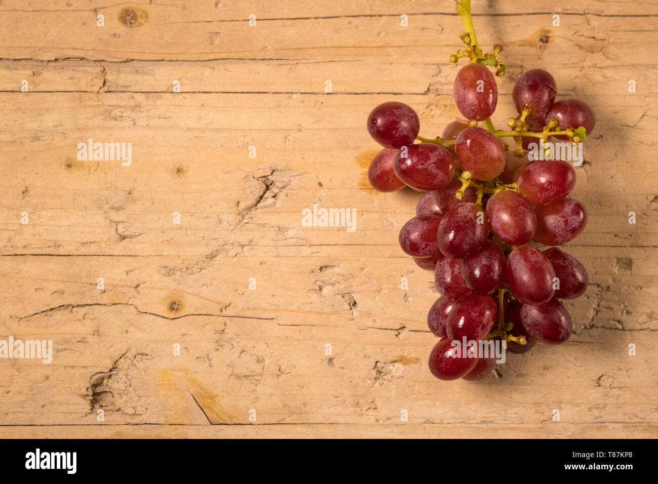 Bunch of grapes without seeds isolated on old wooden background, with ...