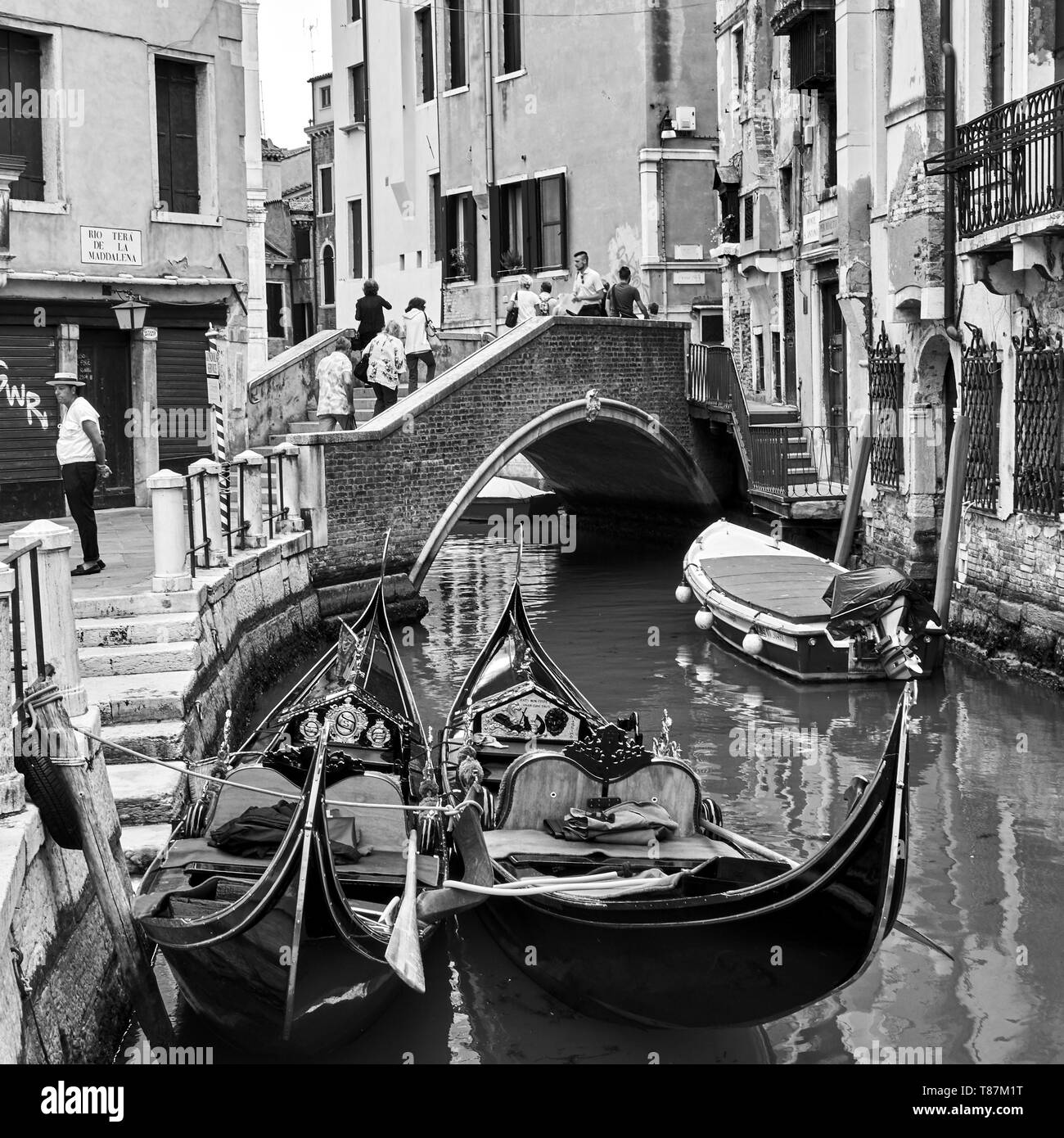 Venice, Italy - June 18, 2018: Two gondolas on canal near small bridge ...