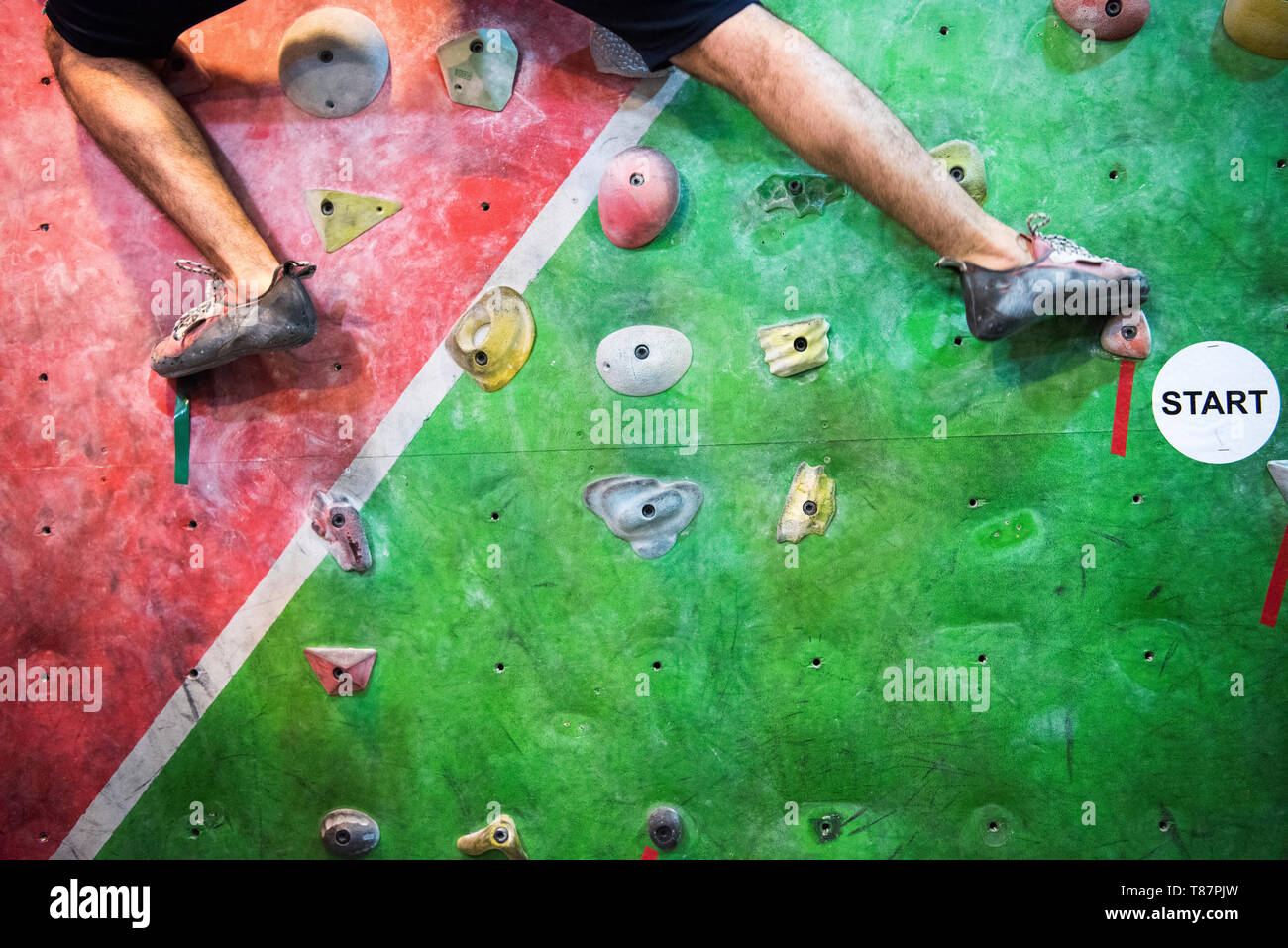 climber legs on the climbing wall.start point Stock Photo - Alamy