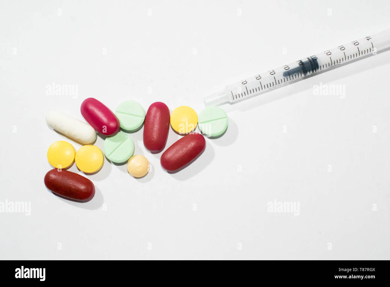 Medical tablets and an injection isolated on white background Stock ...