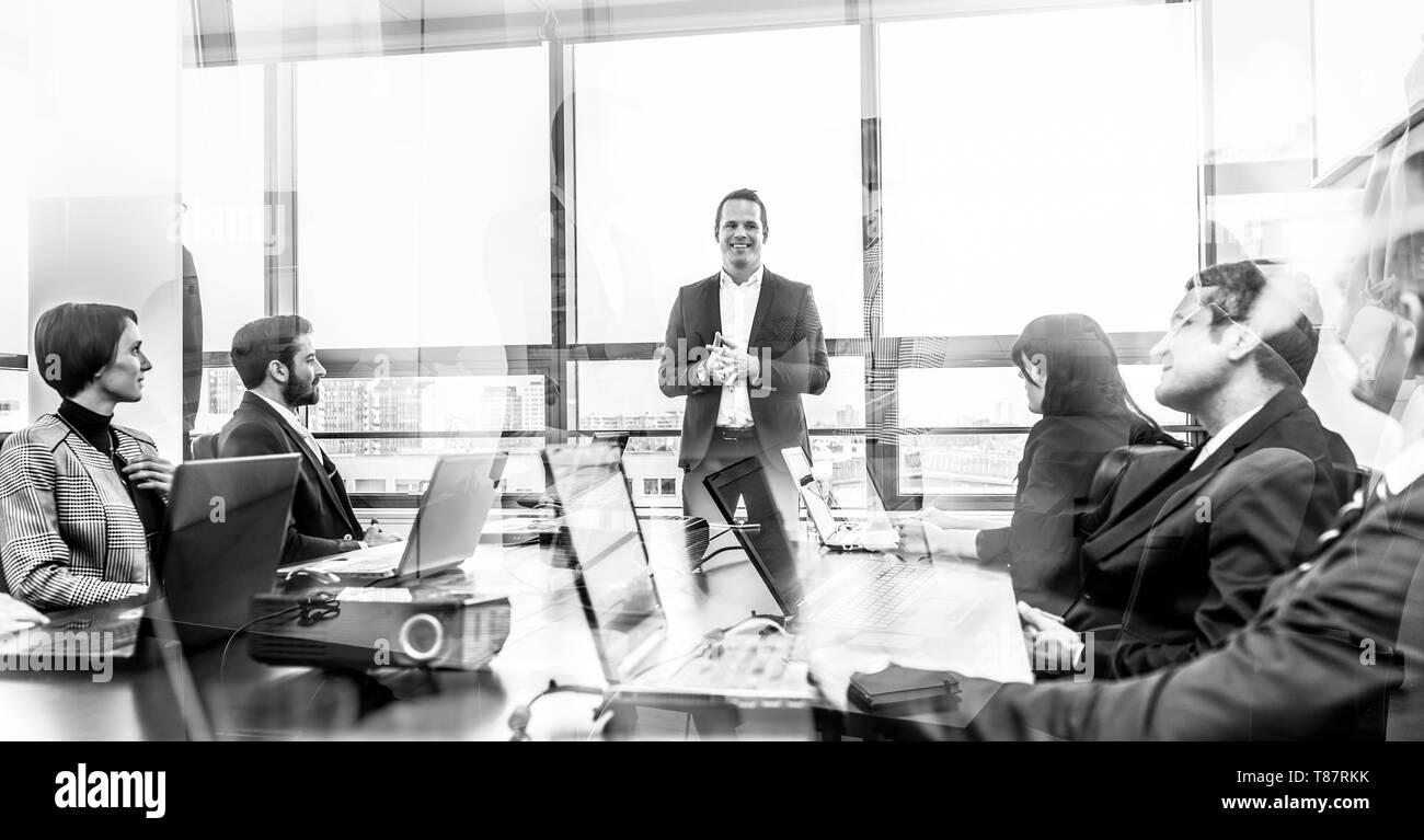 Successful businessman leading team Black and White Stock Photos ...