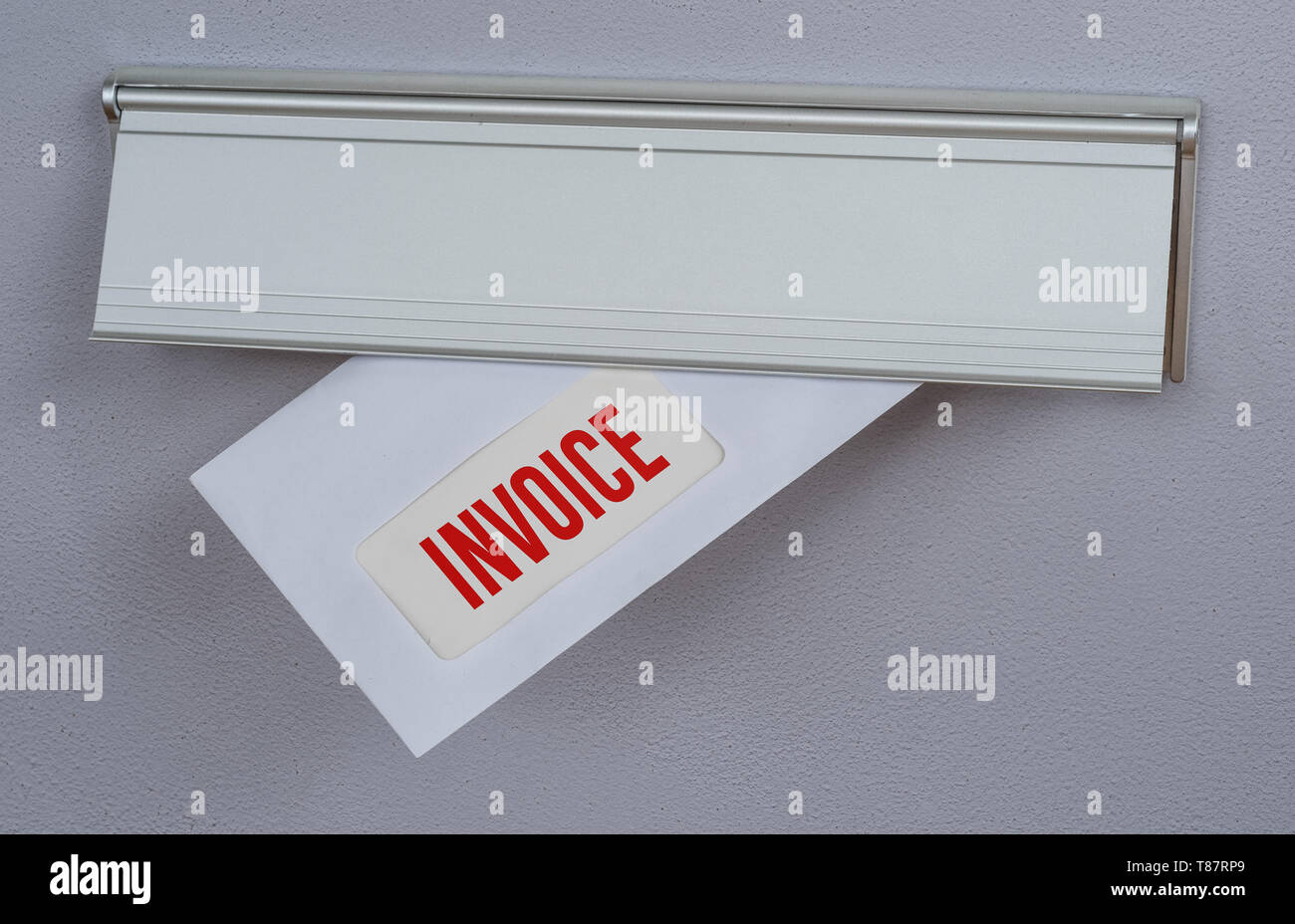A letter in a mail slot - Invoice Stock Photo - Alamy