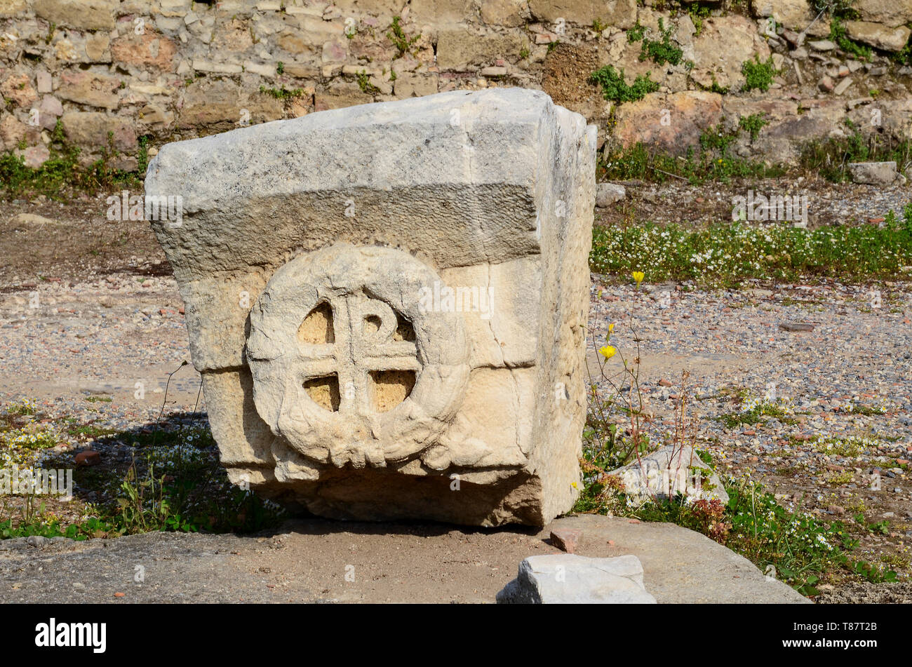 A piece of stone wall with a bas-relief of a Byzantine cross Stock ...