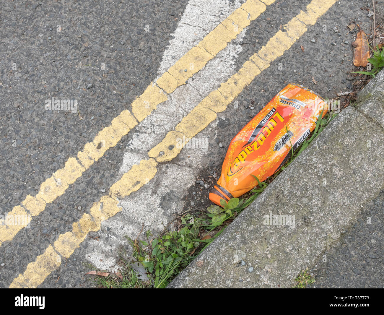 Empty plastic bottle lying in street gutter. Plastic waste / war on ...