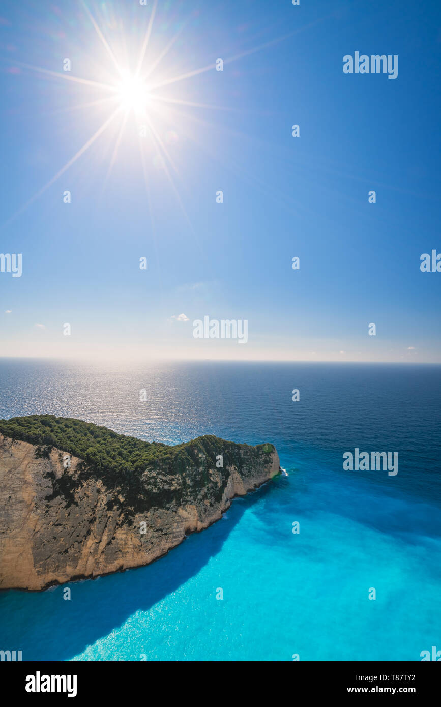 Vertical view of the sun shining over cliffs in Shipwreck Cove in ...