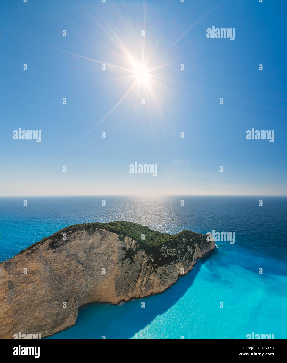 Vertical view of the sun shining over cliffs in Shipwreck Cove in ...