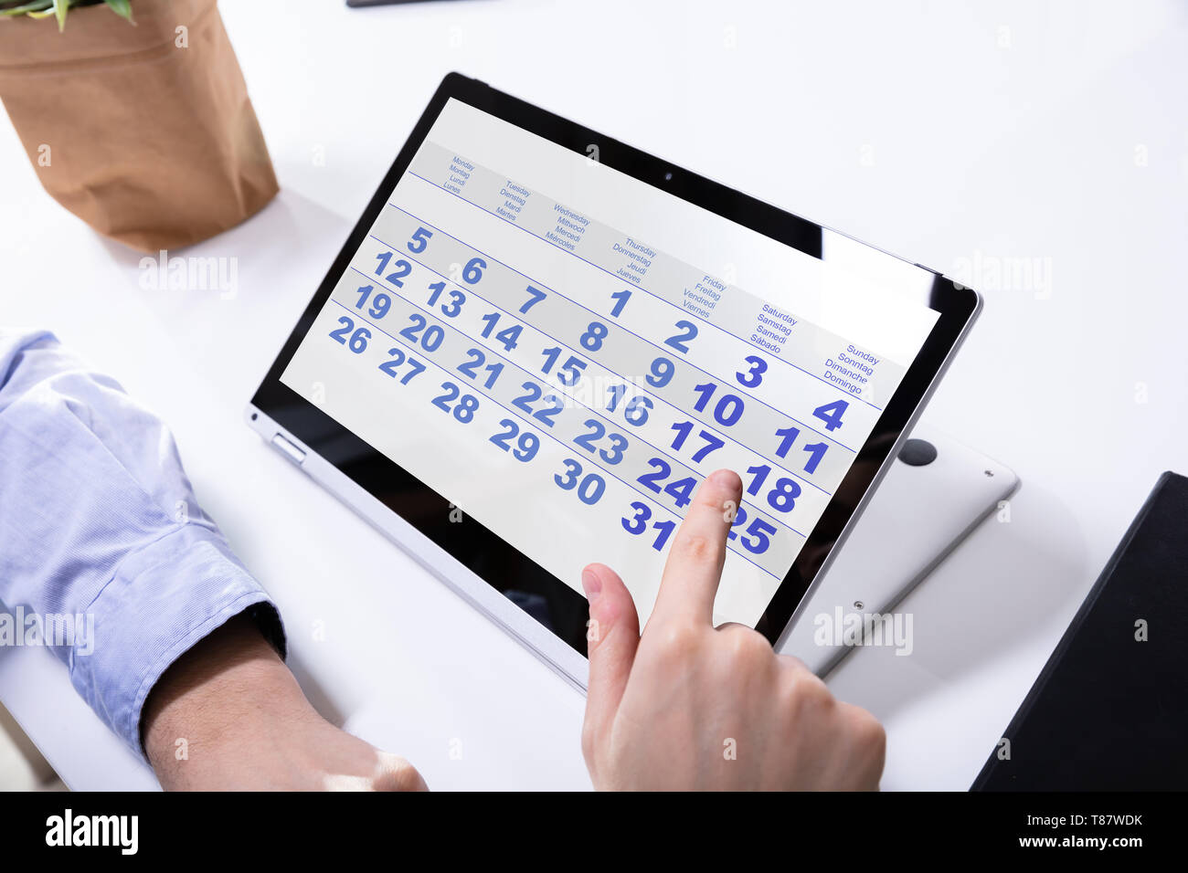 Close-up Of A Businessman's Hand Using Calendar On Laptop Over Desk ...