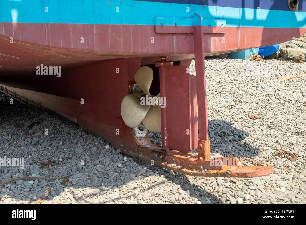 Back of a traditional fishing boat showing the propeller and rudder, on ...