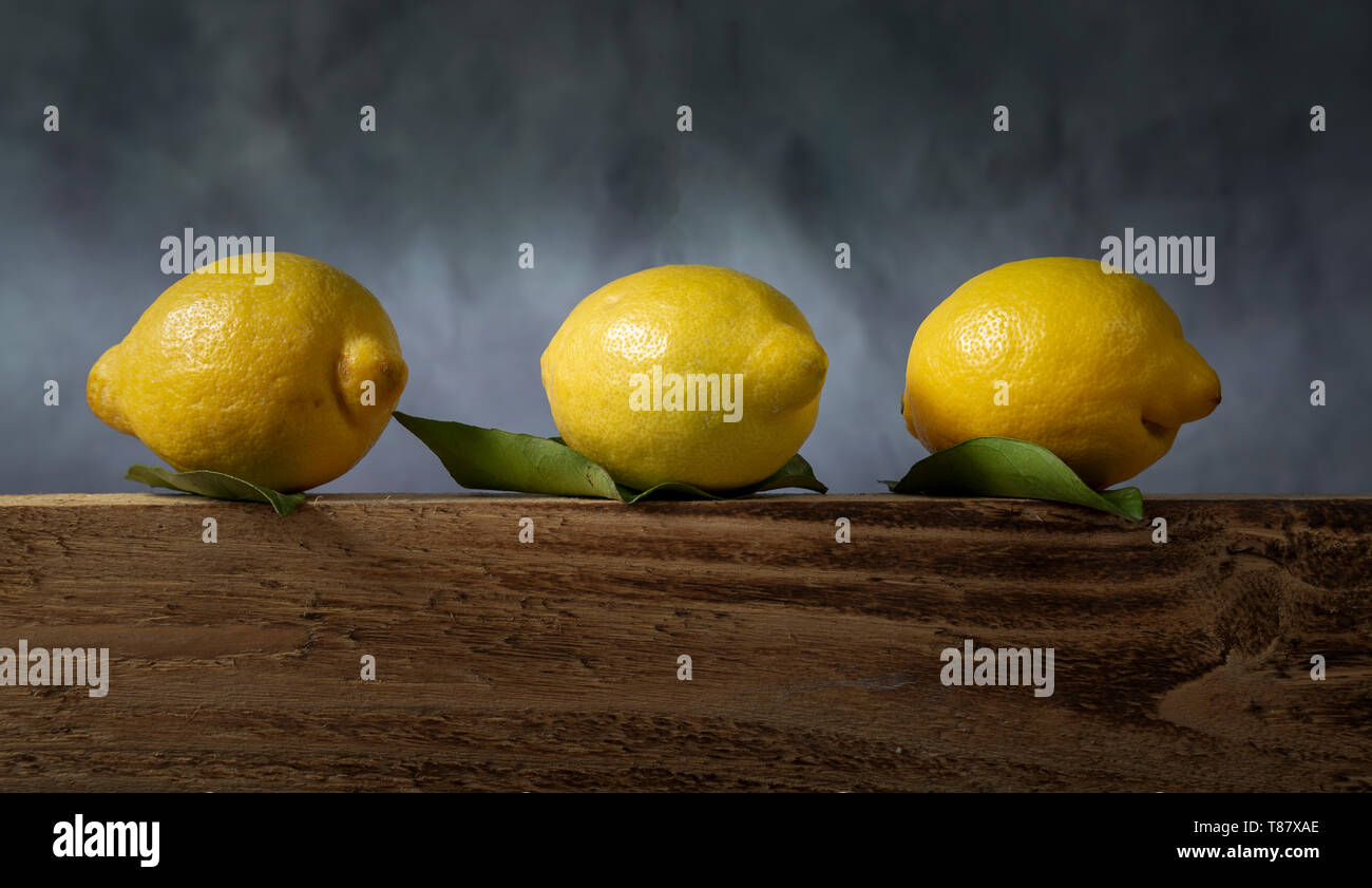 Three lemons with leaves Stock Photo - Alamy
