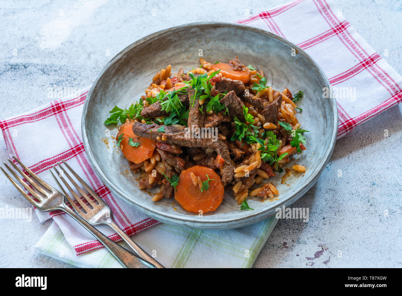 Giouvetsi - traditional Greek baked dish with beef and orzo pasta in ...