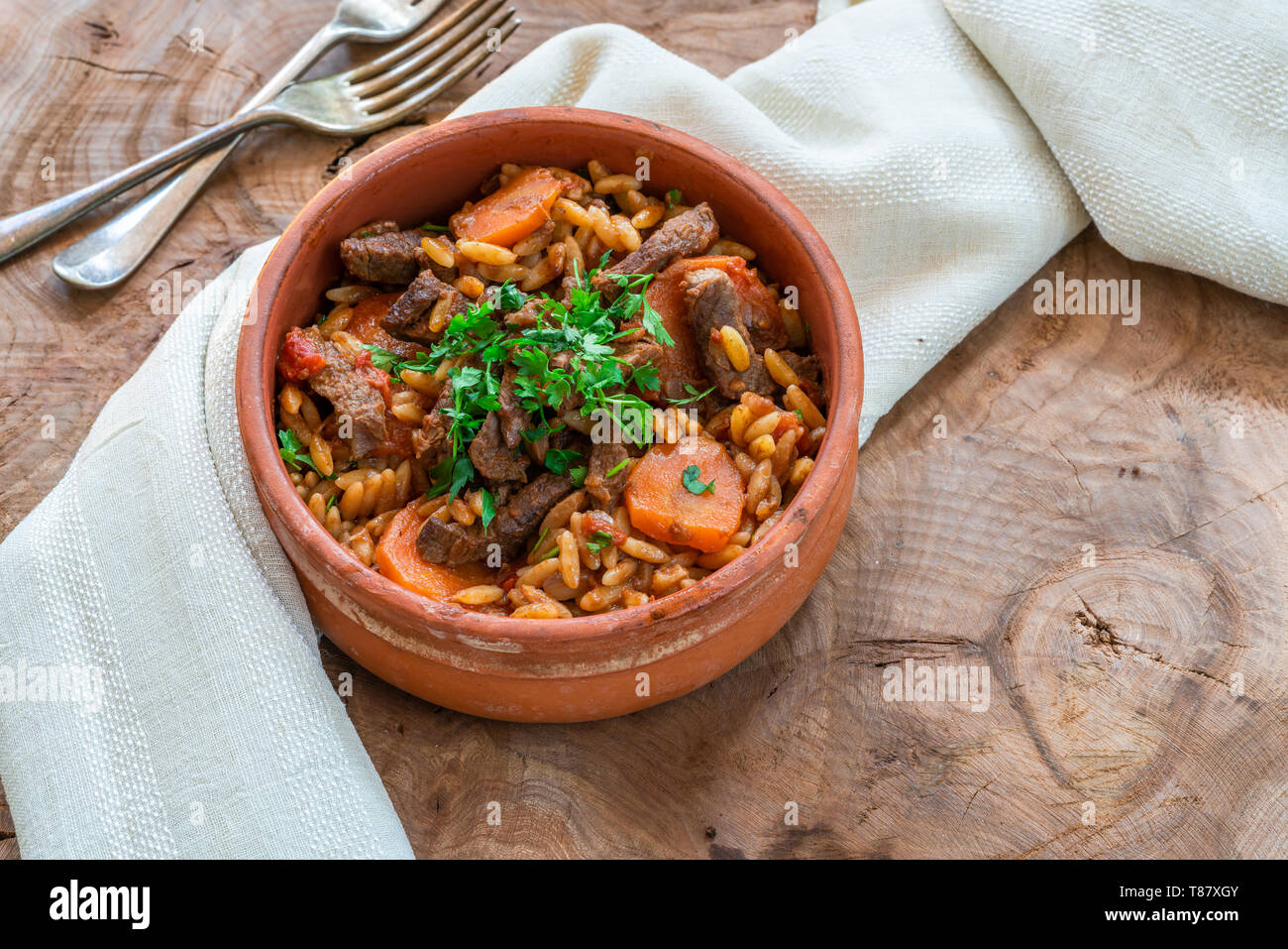 Giouvetsi - traditional Greek baked dish with beef and orzo pasta in ...