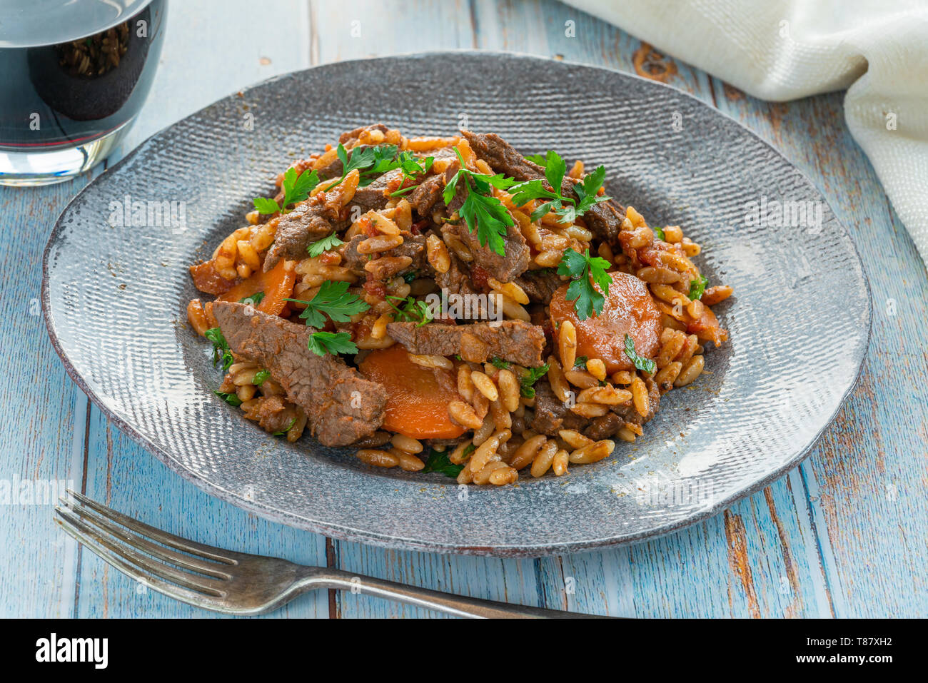 Giouvetsi - traditional Greek baked dish with beef and orzo pasta in ...