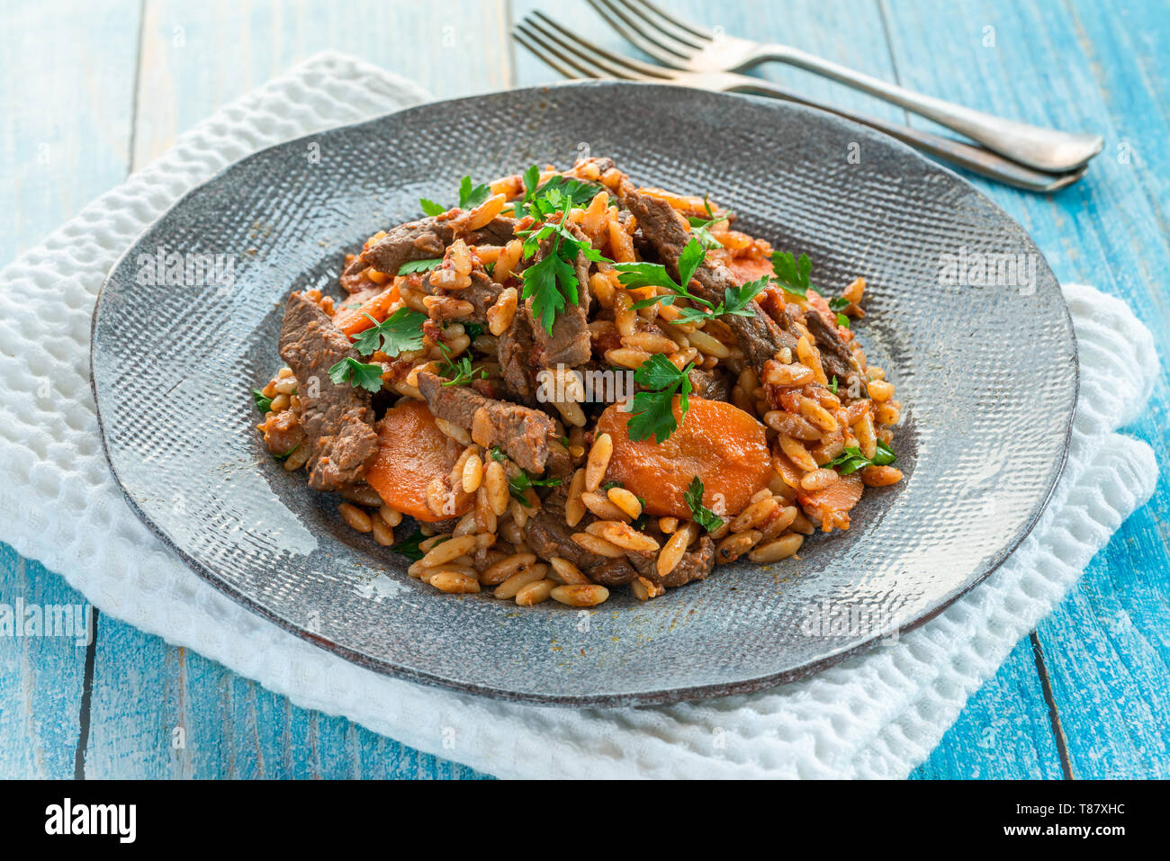 Giouvetsi - traditional Greek baked dish with beef and orzo pasta in ...